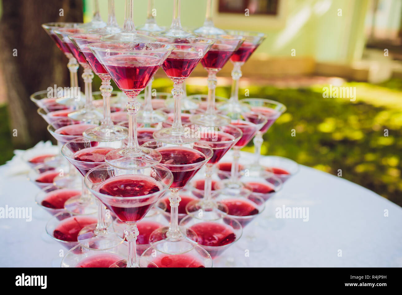 pyramid of glasses of wine, champagne on the street Stock Photo - Alamy