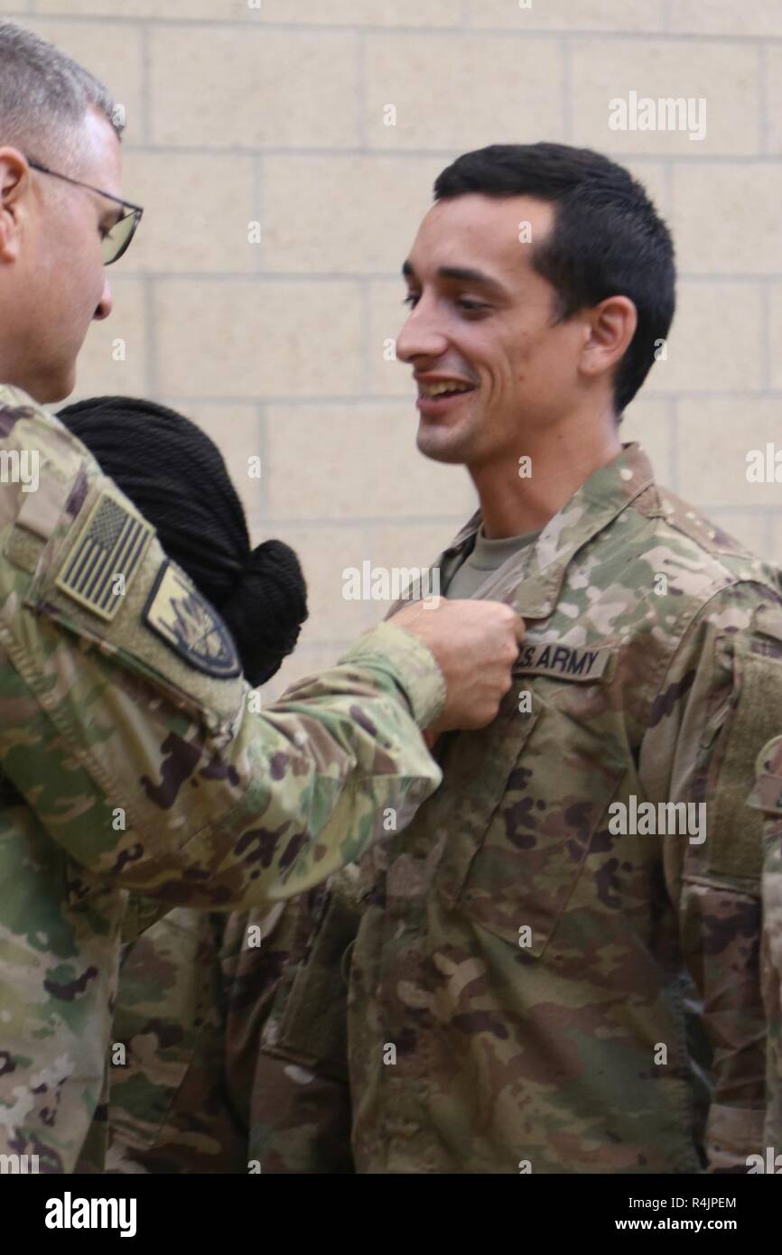 Spc. Tyler Everett receives the Army Achievement Medal from Brig. Gen ...