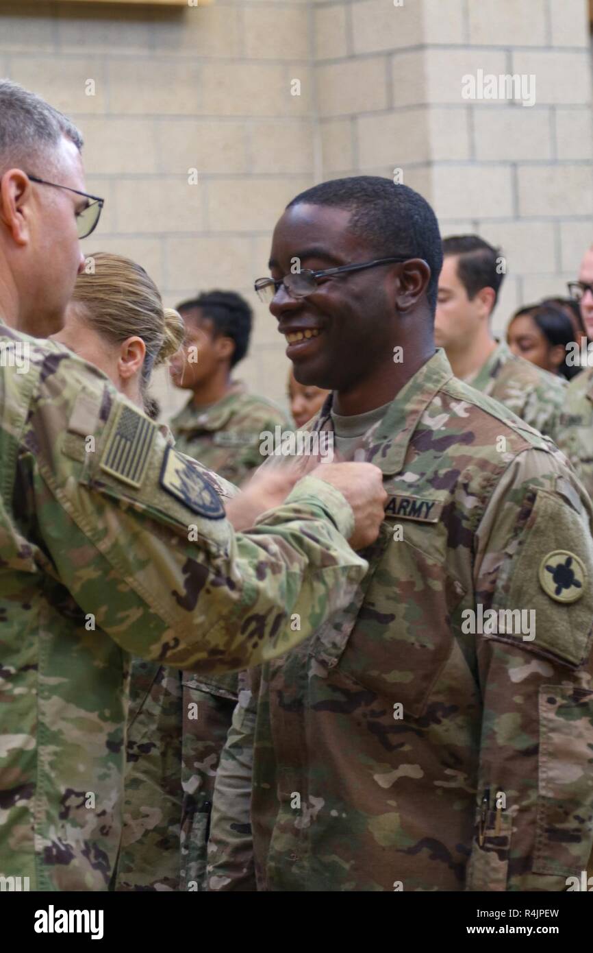 Staff Sgt. Titus Johnson receives the Army Achievement Medal from Brig ...
