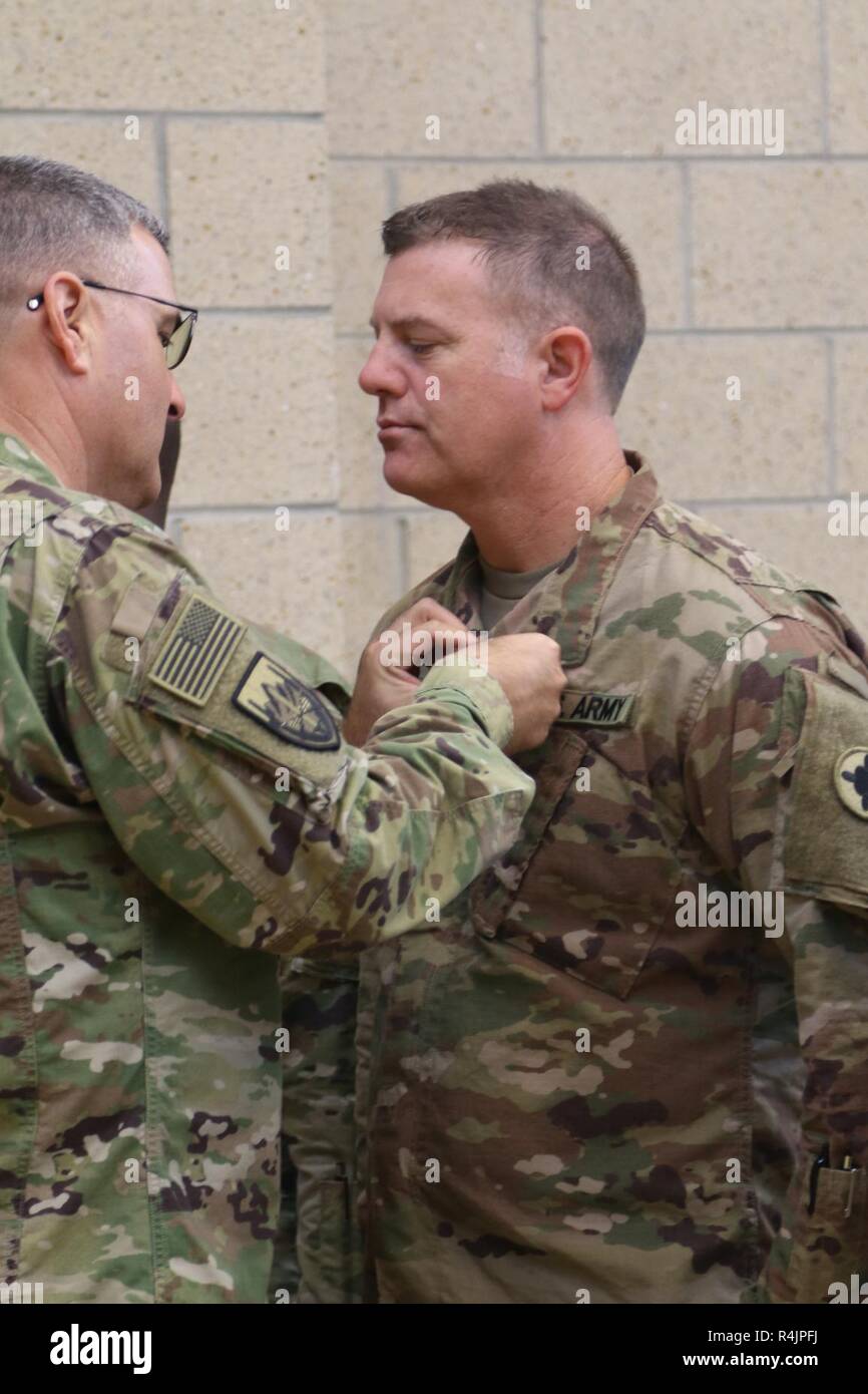 Staff Sgt. Dustin Niemeyer receives the Army Commendation Medal from ...