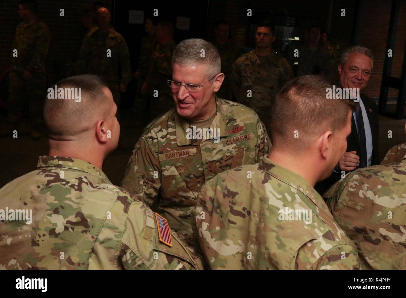 Maj. Gen. Mark E. Bartman (center), Ohio adjutant general, shakes hands ...