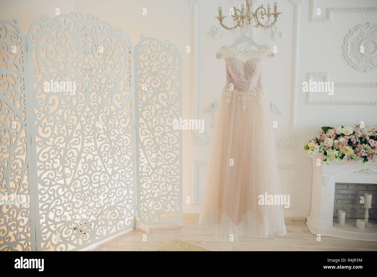 wedding dress hanging on luster at hotel room Stock Photo - Alamy