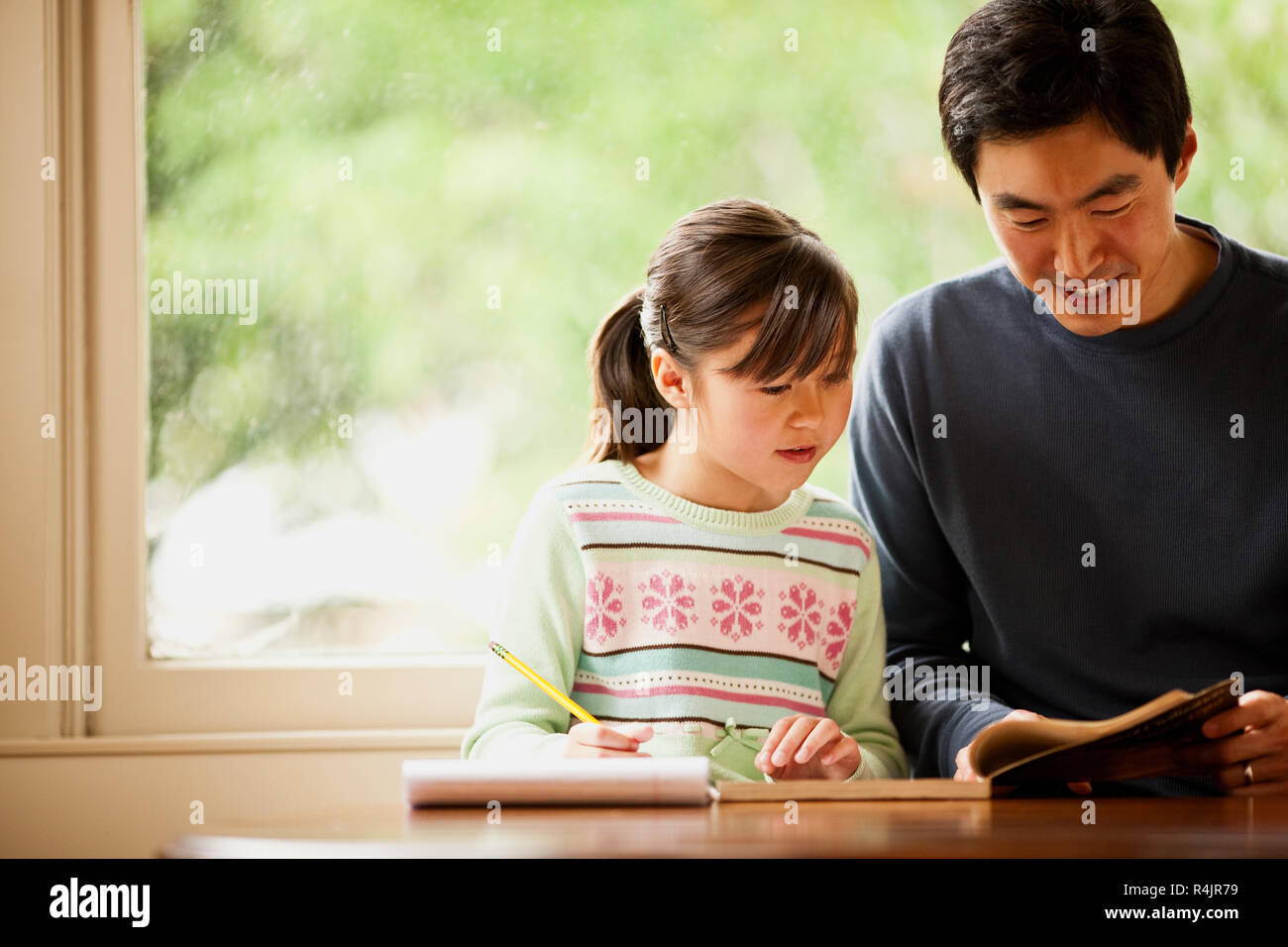 Father helping his daughter with homework Stock Photo - Alamy