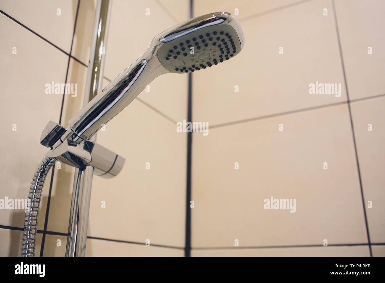 Water running from shower head in bathroom with dark black background ...