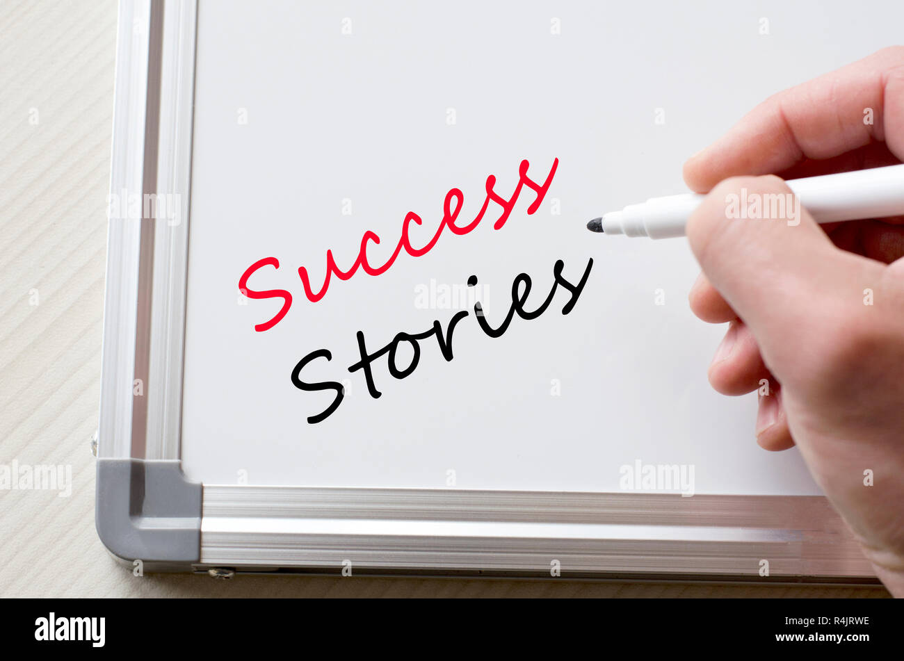 Success stories written on whiteboard Stock Photo - Alamy