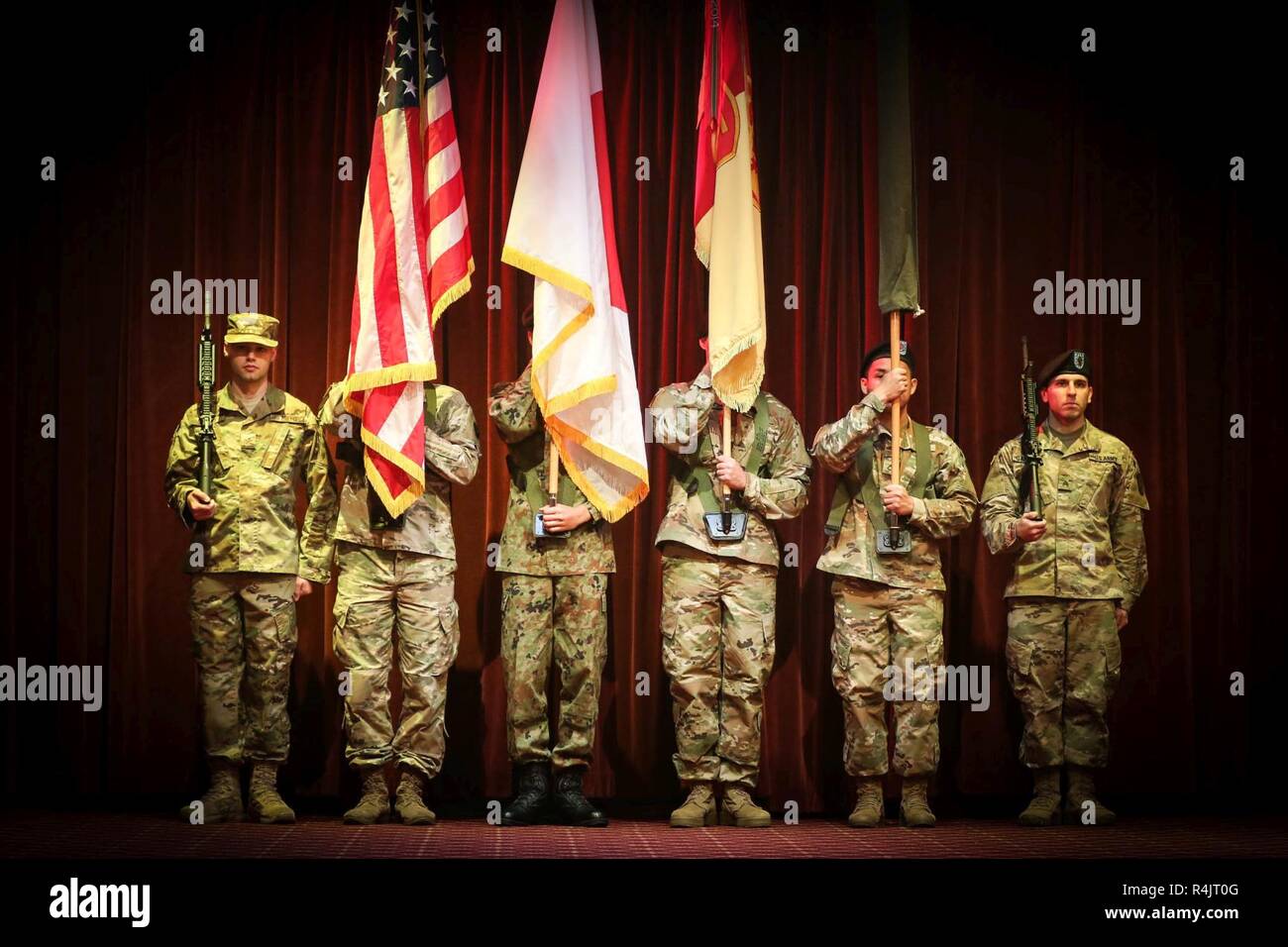 The color guard stands at the position of attention during the ...