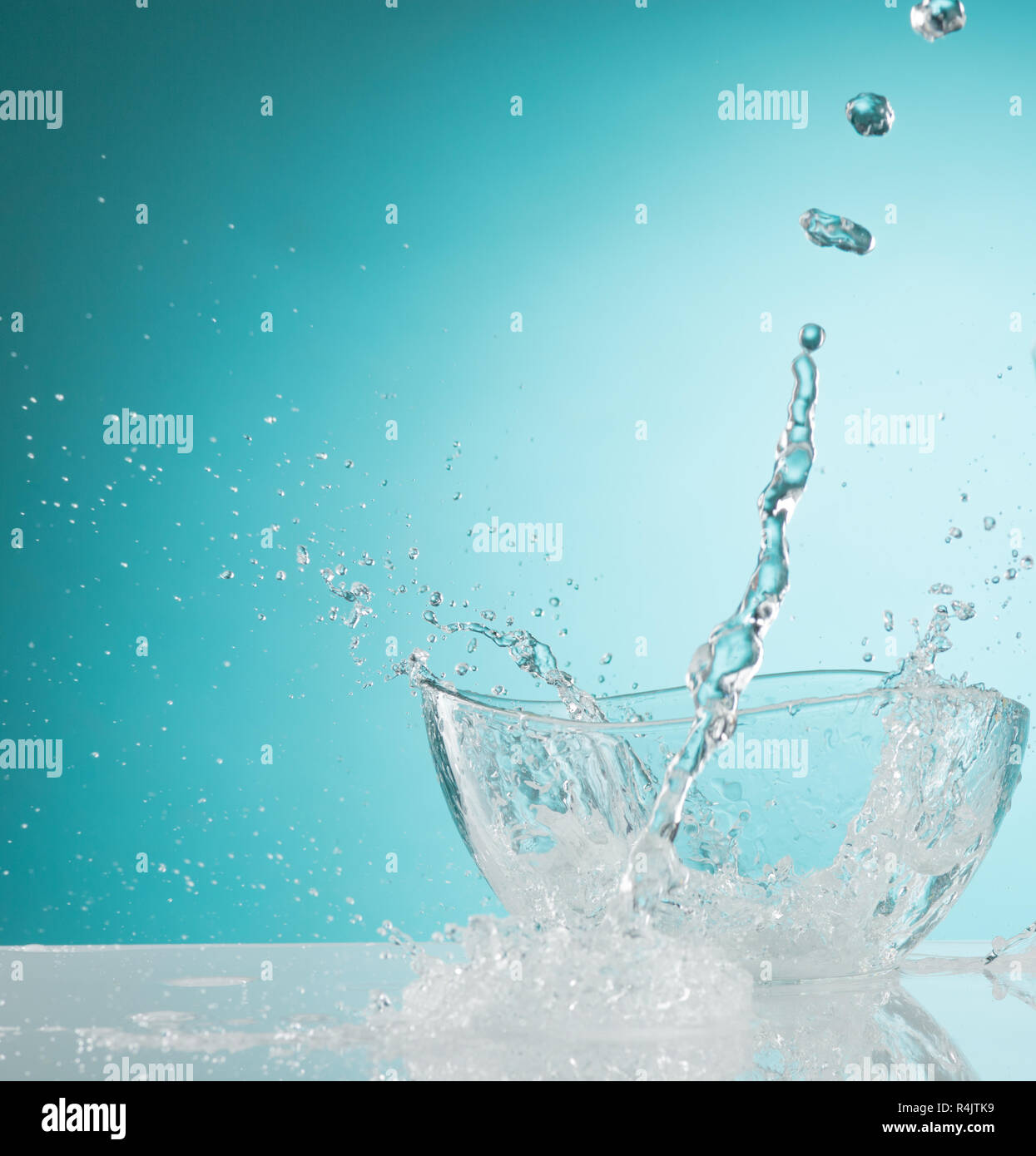 The water splashing to glass bowl on white background Stock Photo - Alamy