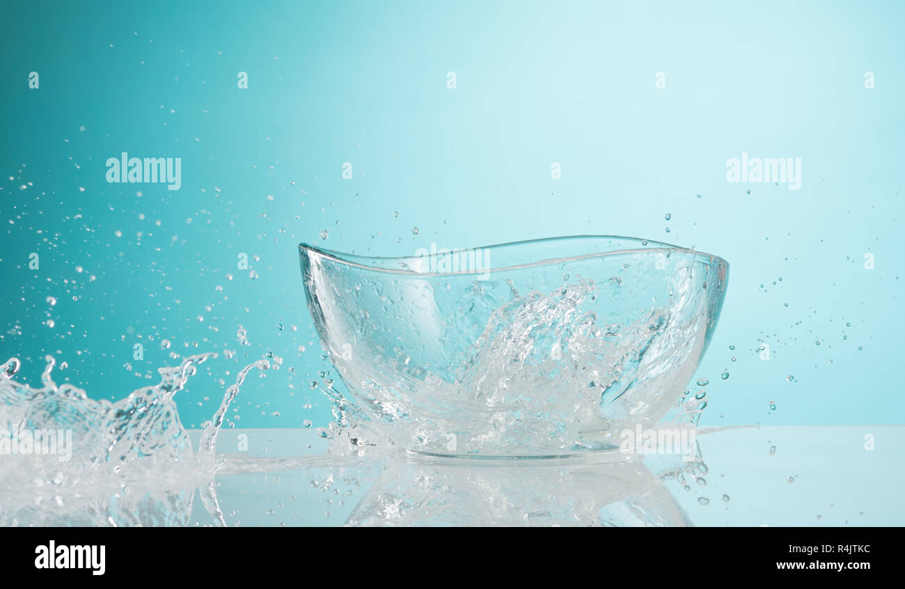 The water splashing to glass bowl on white background Stock Photo - Alamy