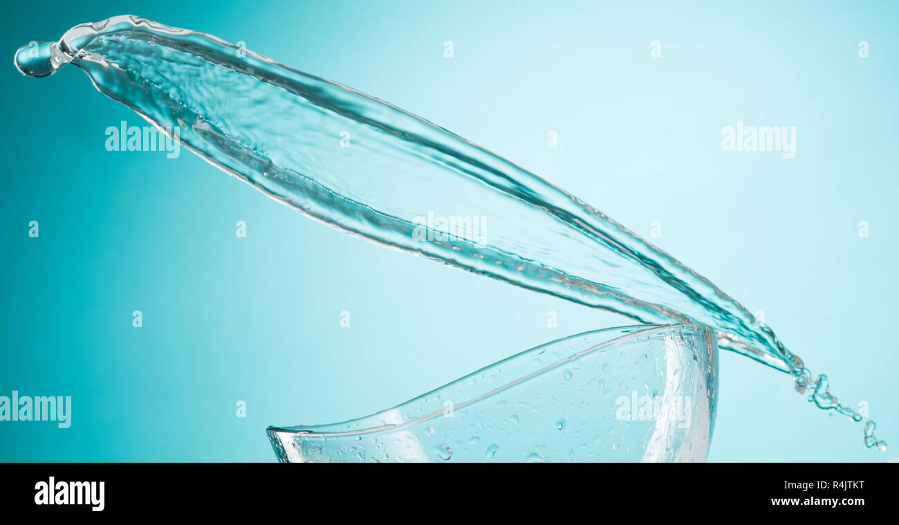 The water splashing to glass bowl on white background Stock Photo - Alamy