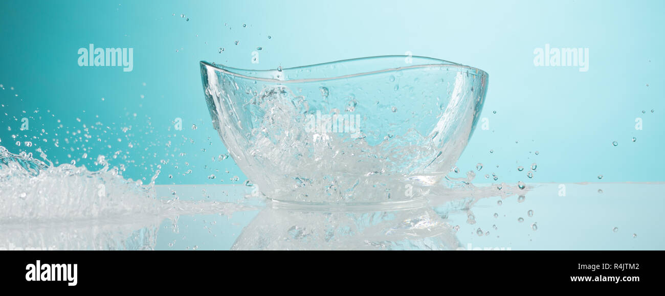 The water splashing to glass bowl on white background Stock Photo - Alamy
