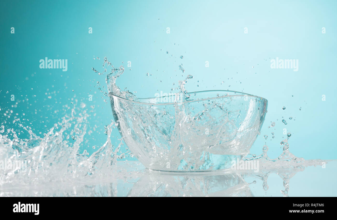 The water splashing to glass bowl on white background Stock Photo - Alamy