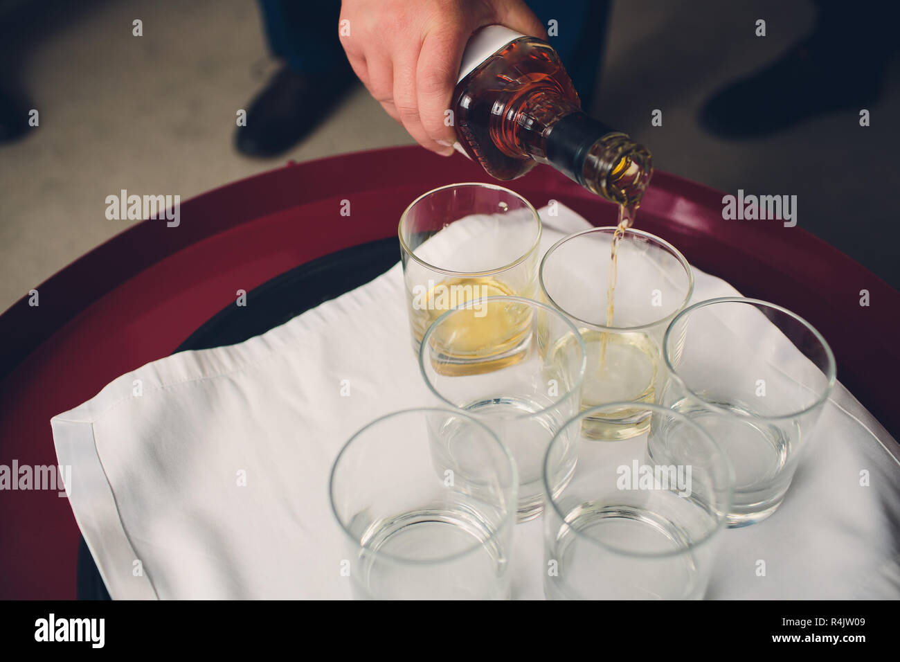 barman pouring alcoholic digestif in glasses at bar Stock Photo - Alamy