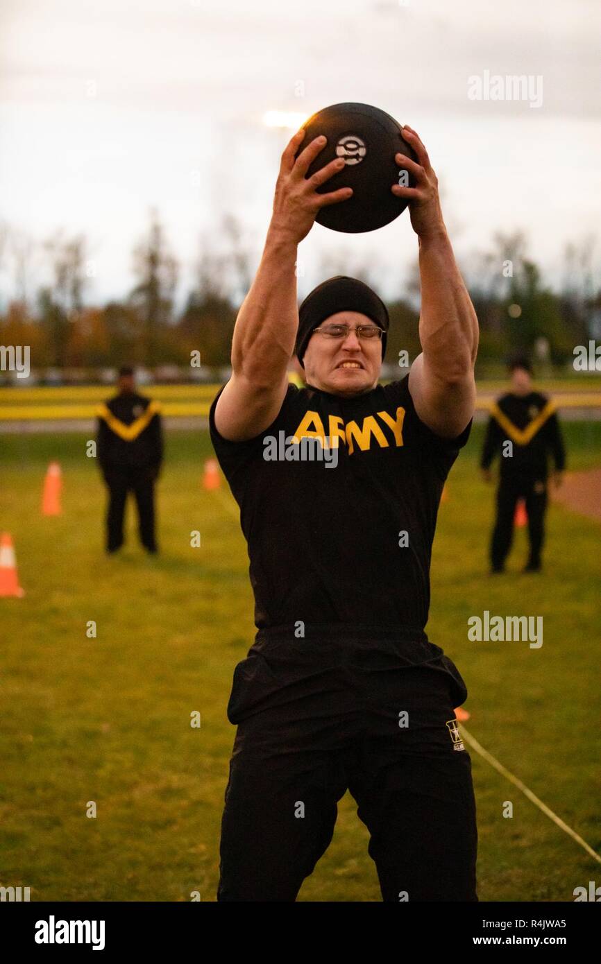 Sgt. Michael Hull, 1-87IN, 1BCT10MTN, hurls a 10 pound ball during the ...