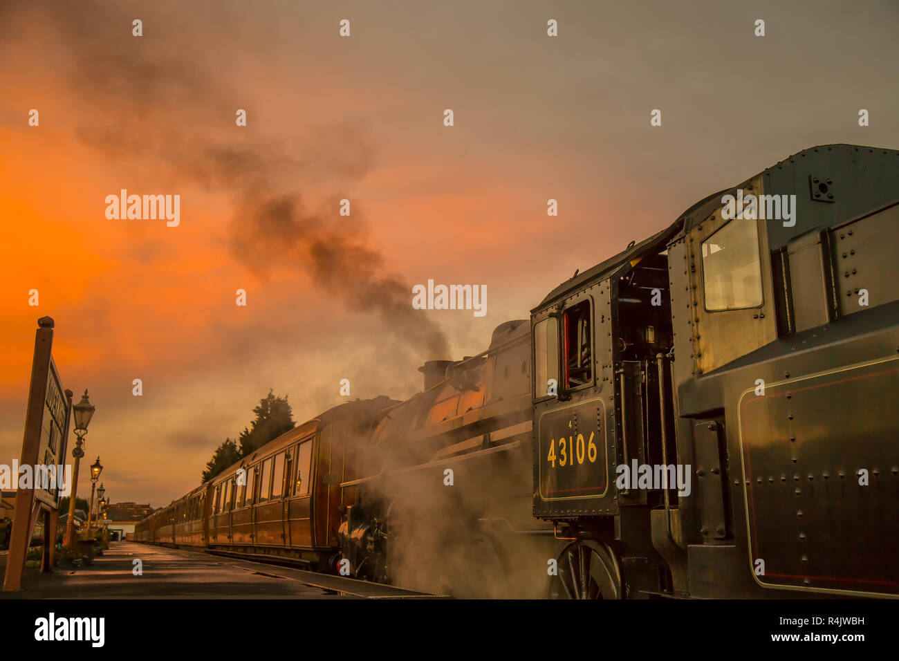 Low angle, side view close up of vintage UK steam train by platform in ...