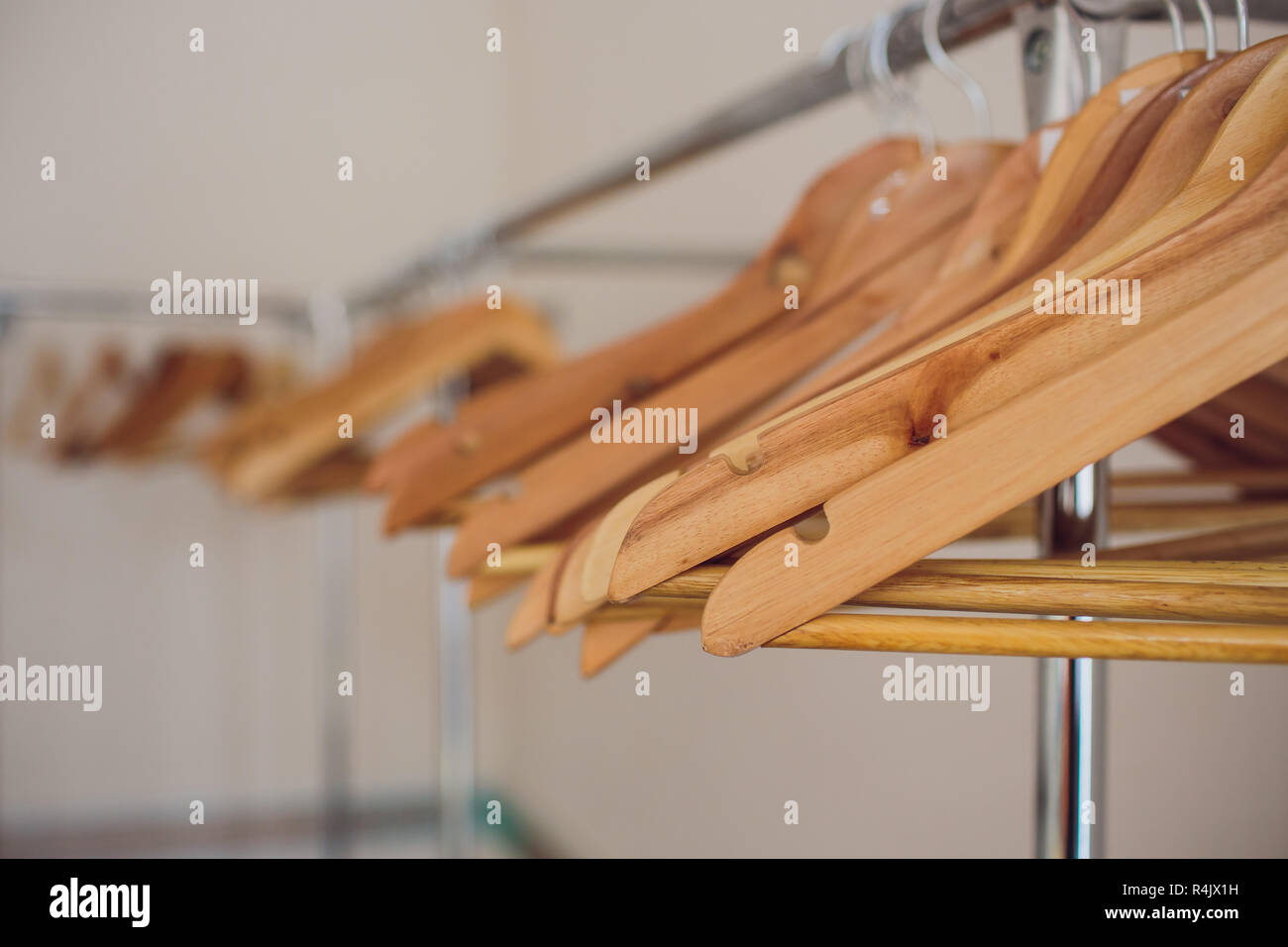 Hanger hanging on clothes rack in bedroom Stock Photo - Alamy