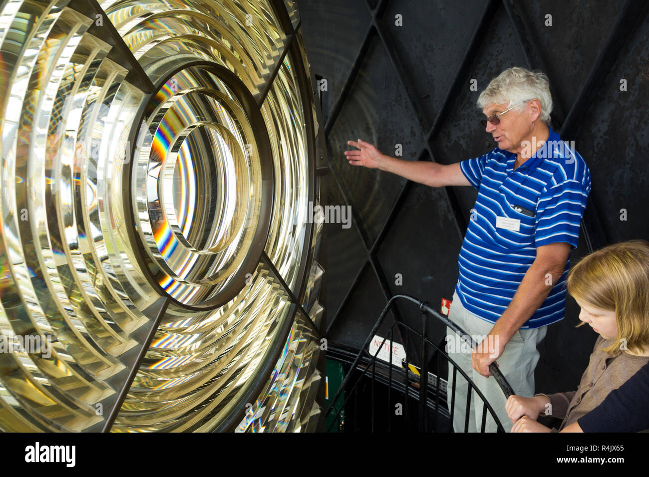 Volunteer guide shows child visitor the specially shaped prisms which ...