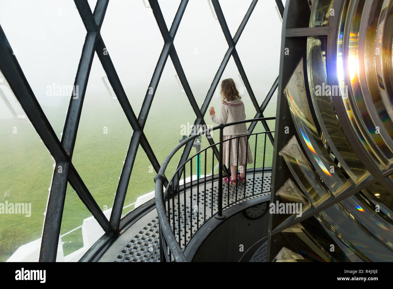Girl aged 6 years / age 6 yr old looking out from the lantern room ...