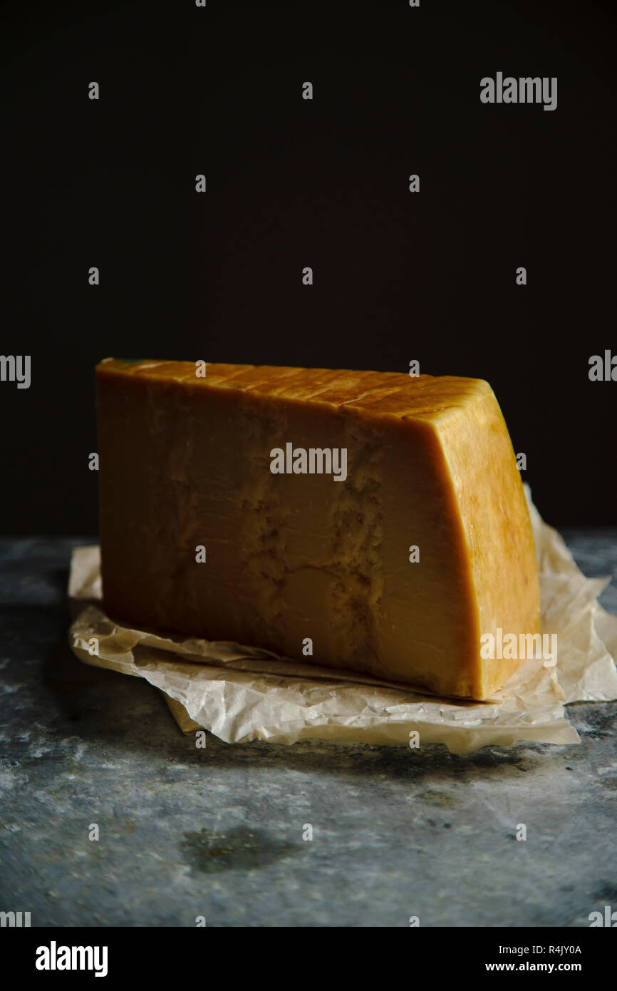 A block of parmesan cheese on metallic surface Stock Photo - Alamy