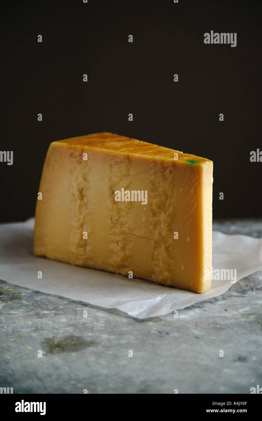 A block of parmesan cheese on metallic surface Stock Photo - Alamy