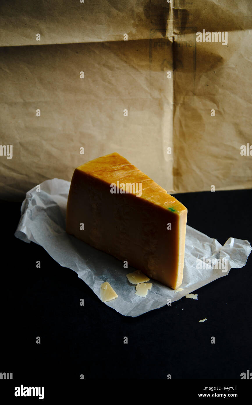 A block of parmesan cheese on dark background Stock Photo - Alamy