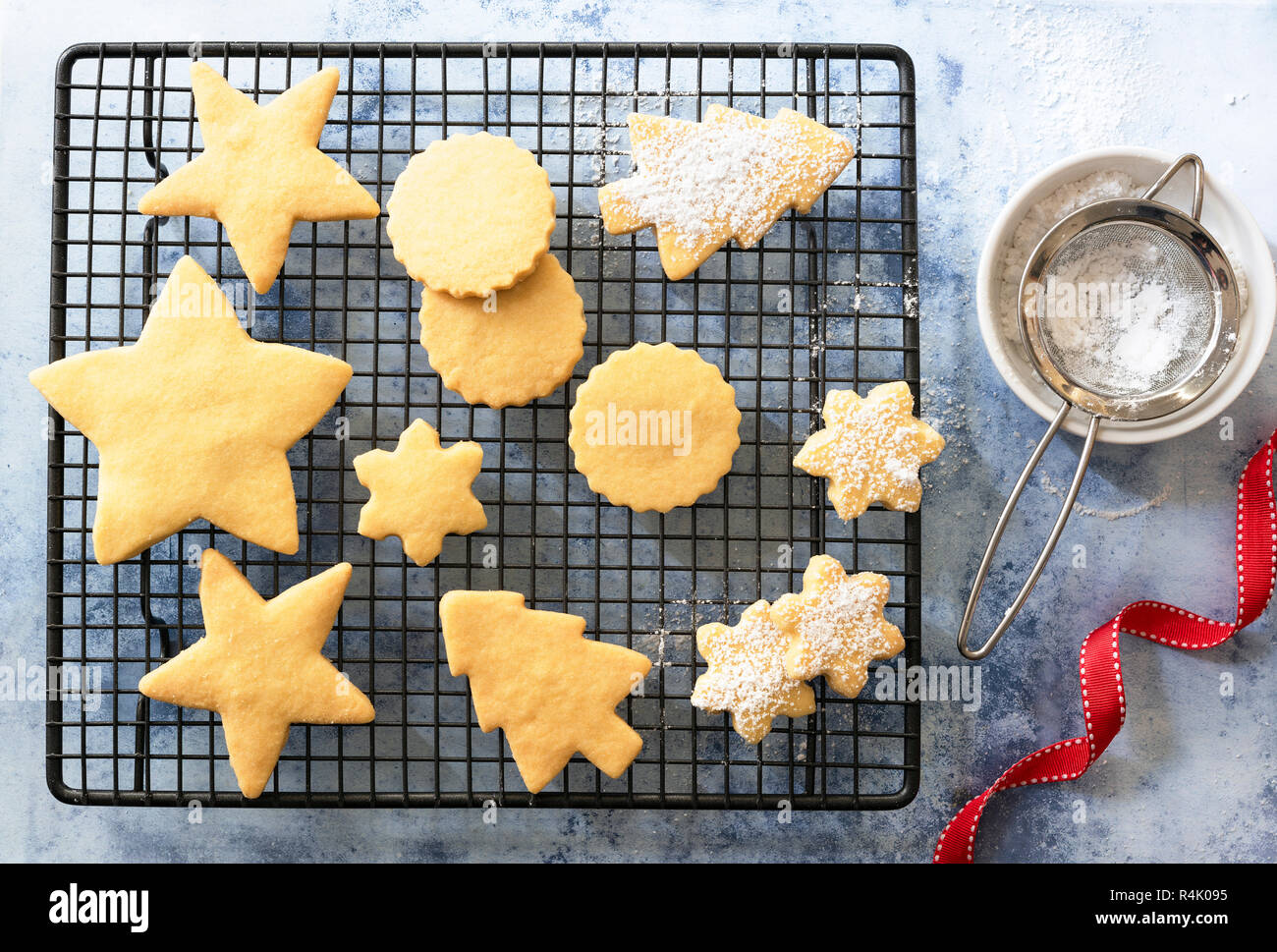 Different shaped Christmas Shortbread biscuits partially covered with ...