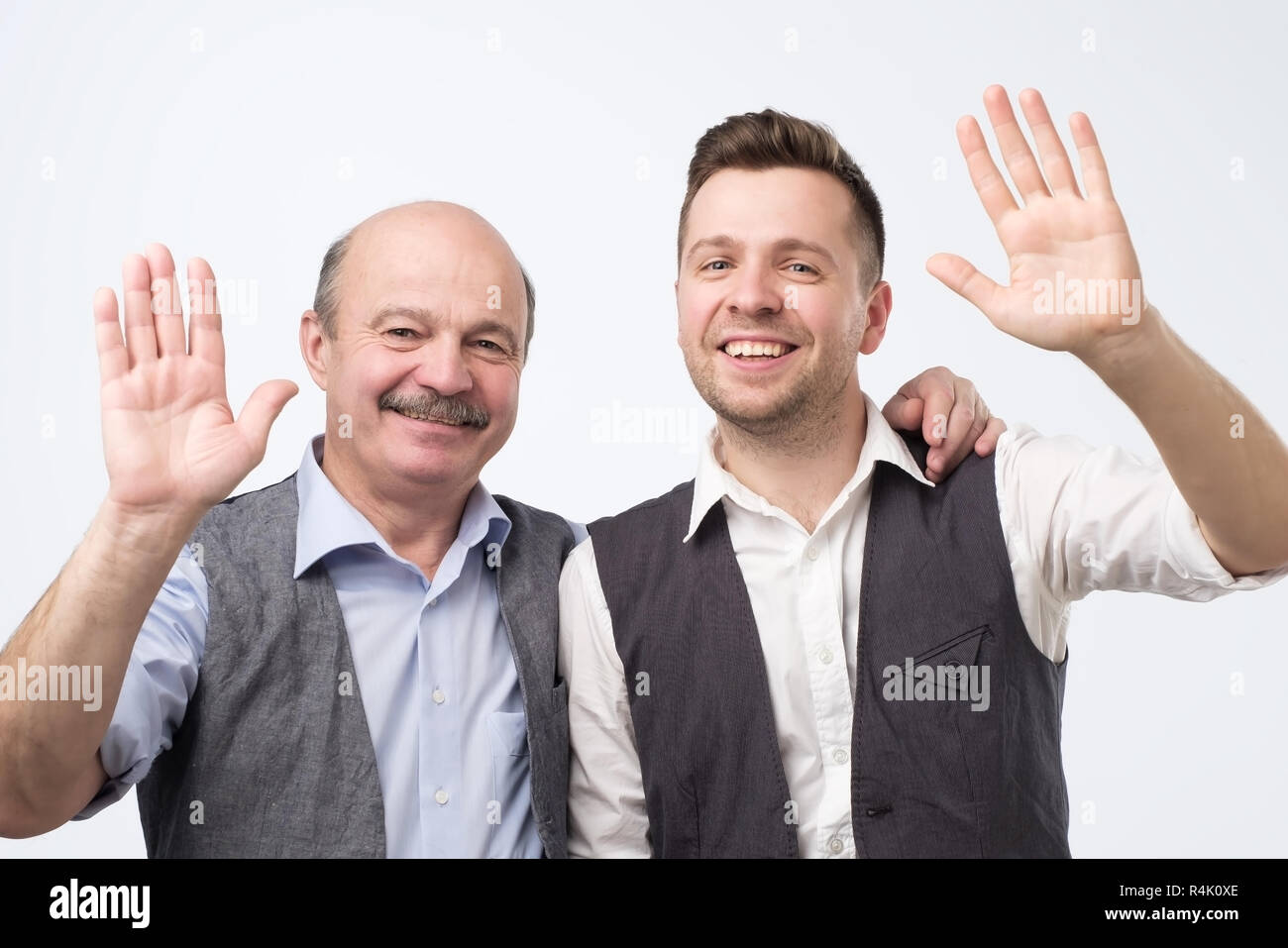 Two People Waving Hello