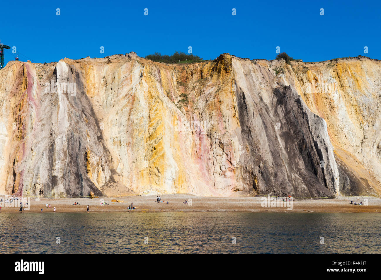 Famous multi coloured layered sands of the sandy cliffs of Alum Bay ...
