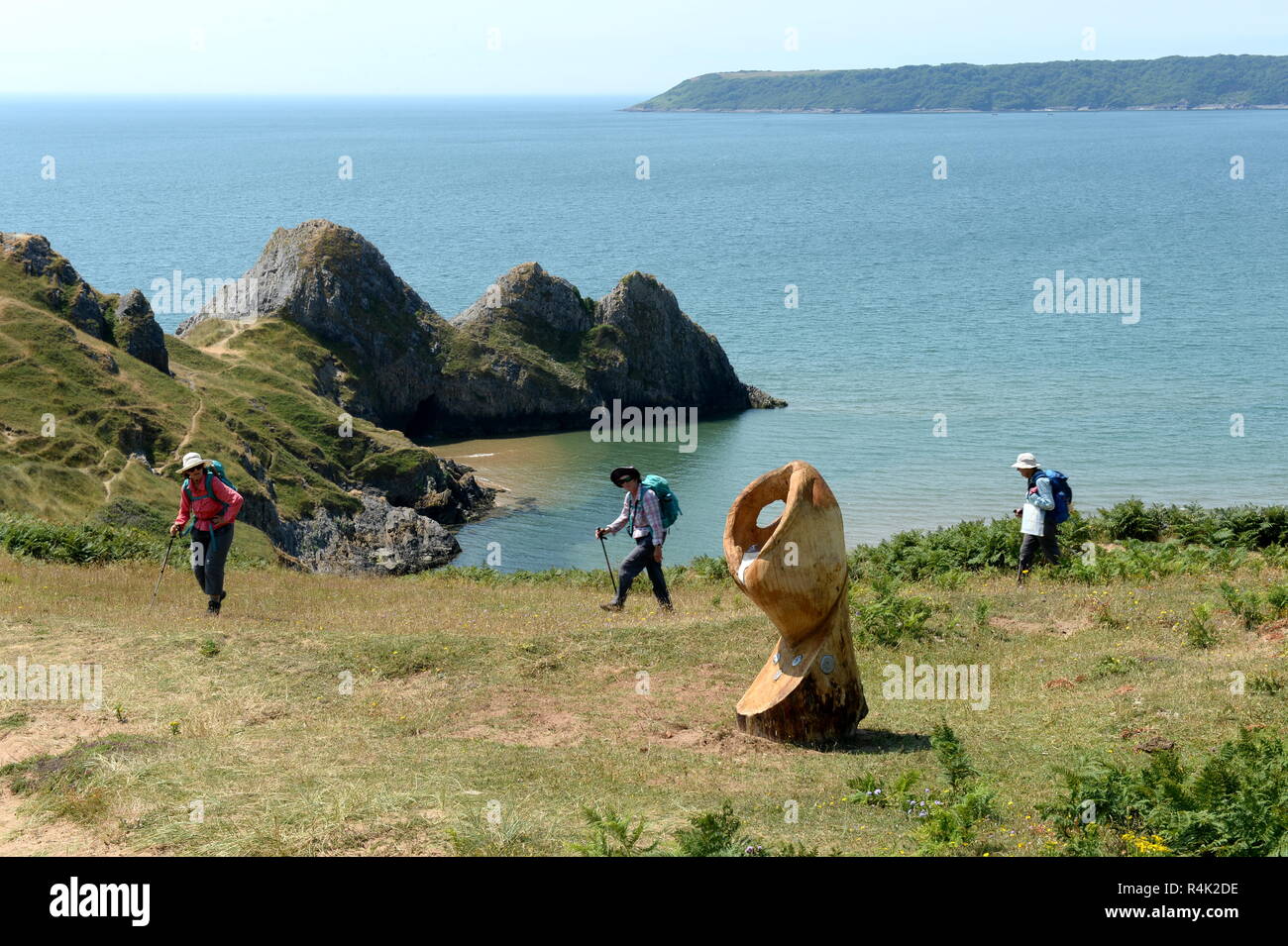 Walkers on the Sculpture trail following the coast path Gower UK at ...