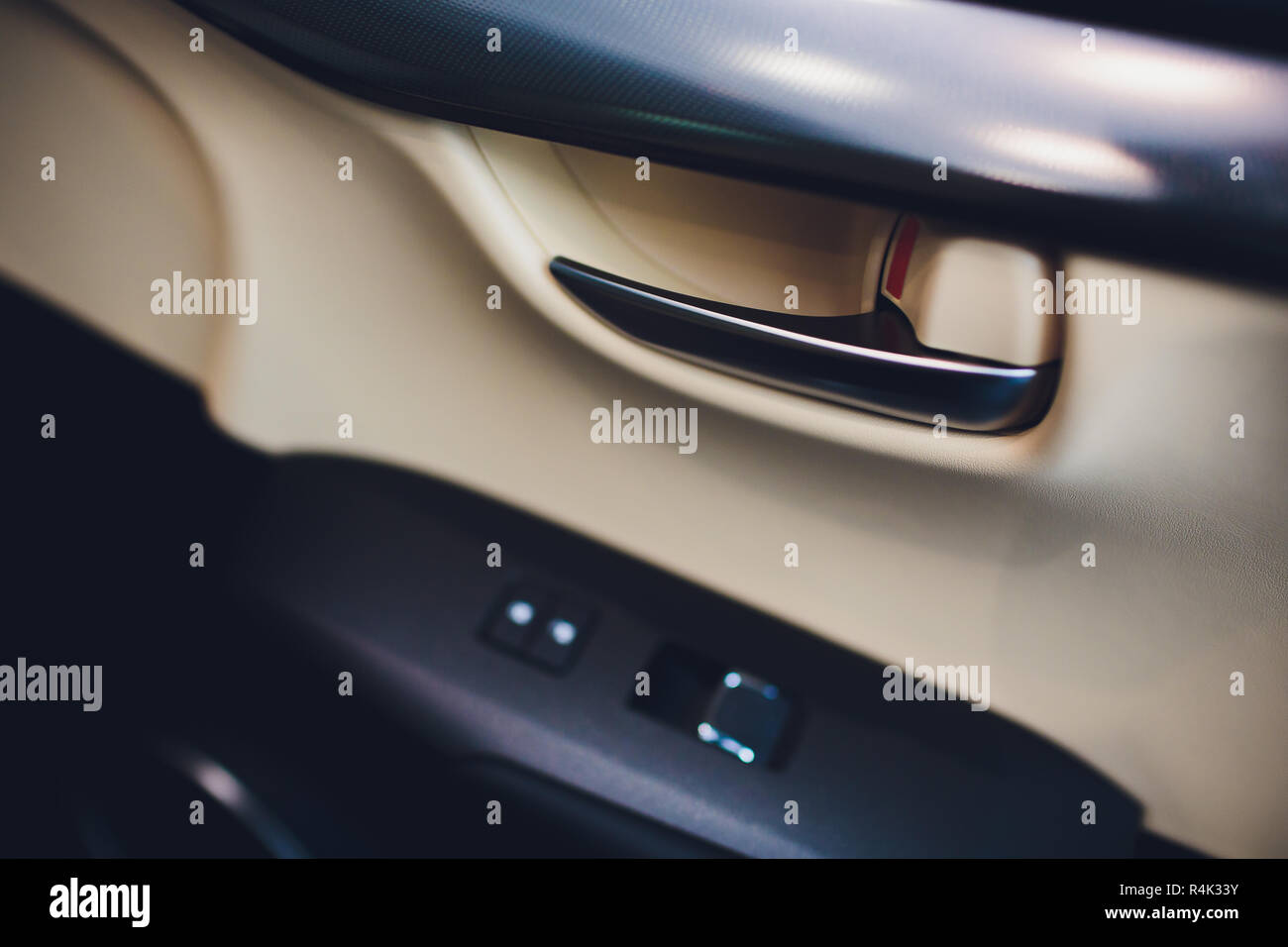 car leather interior details of door handle with windows controls and ...