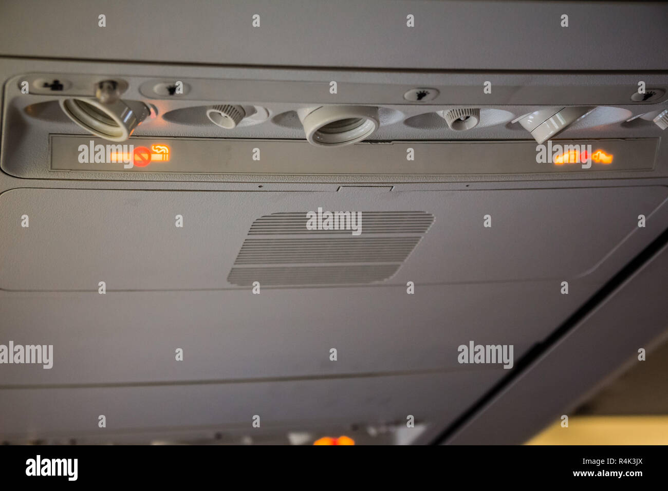 No Smoking and Fasten Seatbelt sign Inside an airplane Stock Photo - Alamy