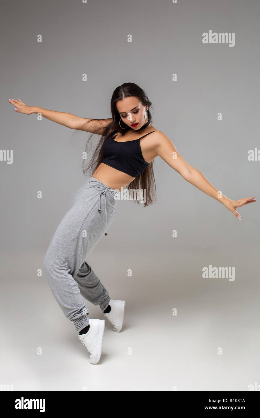 Modern dancer poses in front of the gray studio background. Modern ...