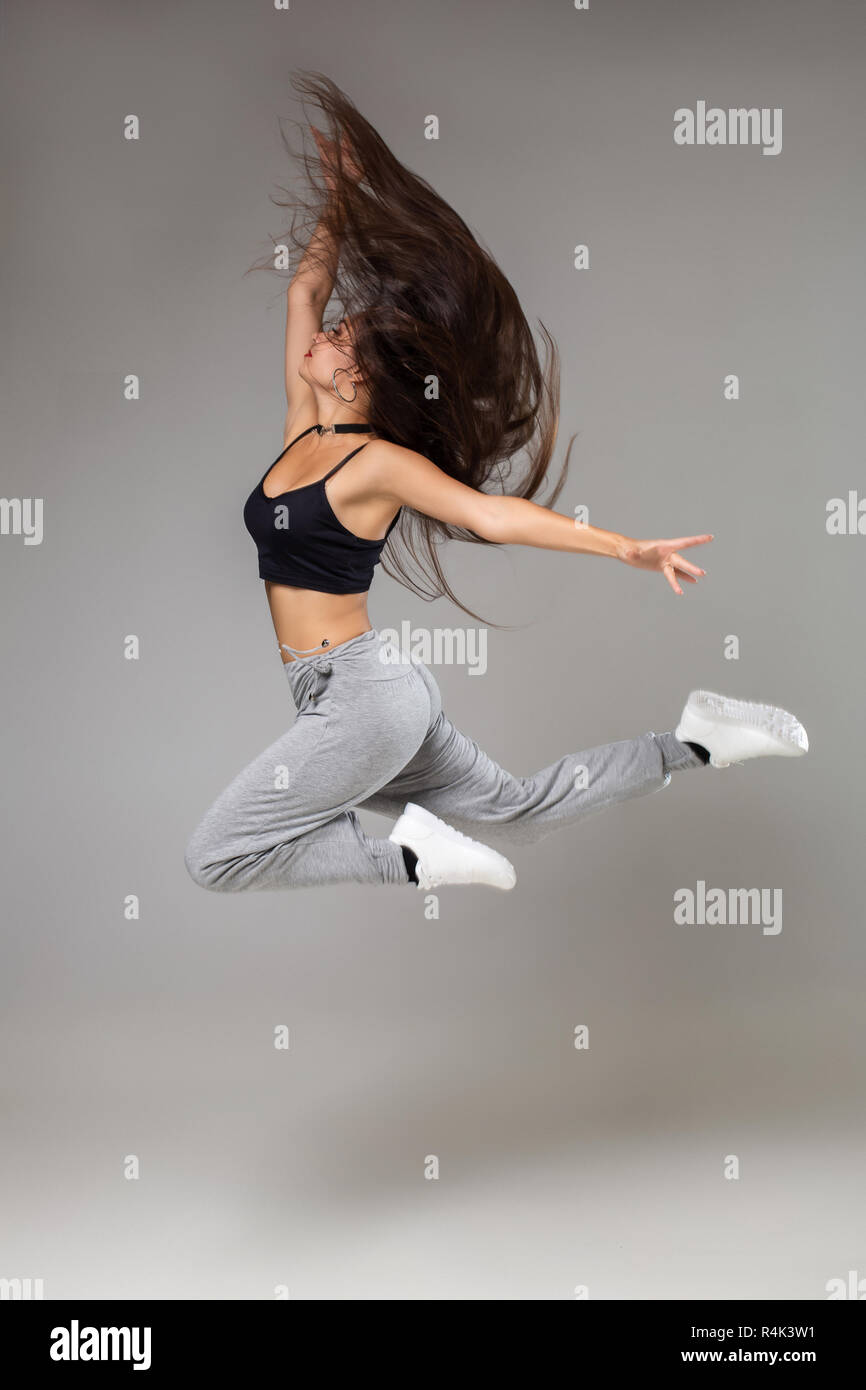 Modern style dancer posing on studio background. Dancing. Hobby. Hip ...