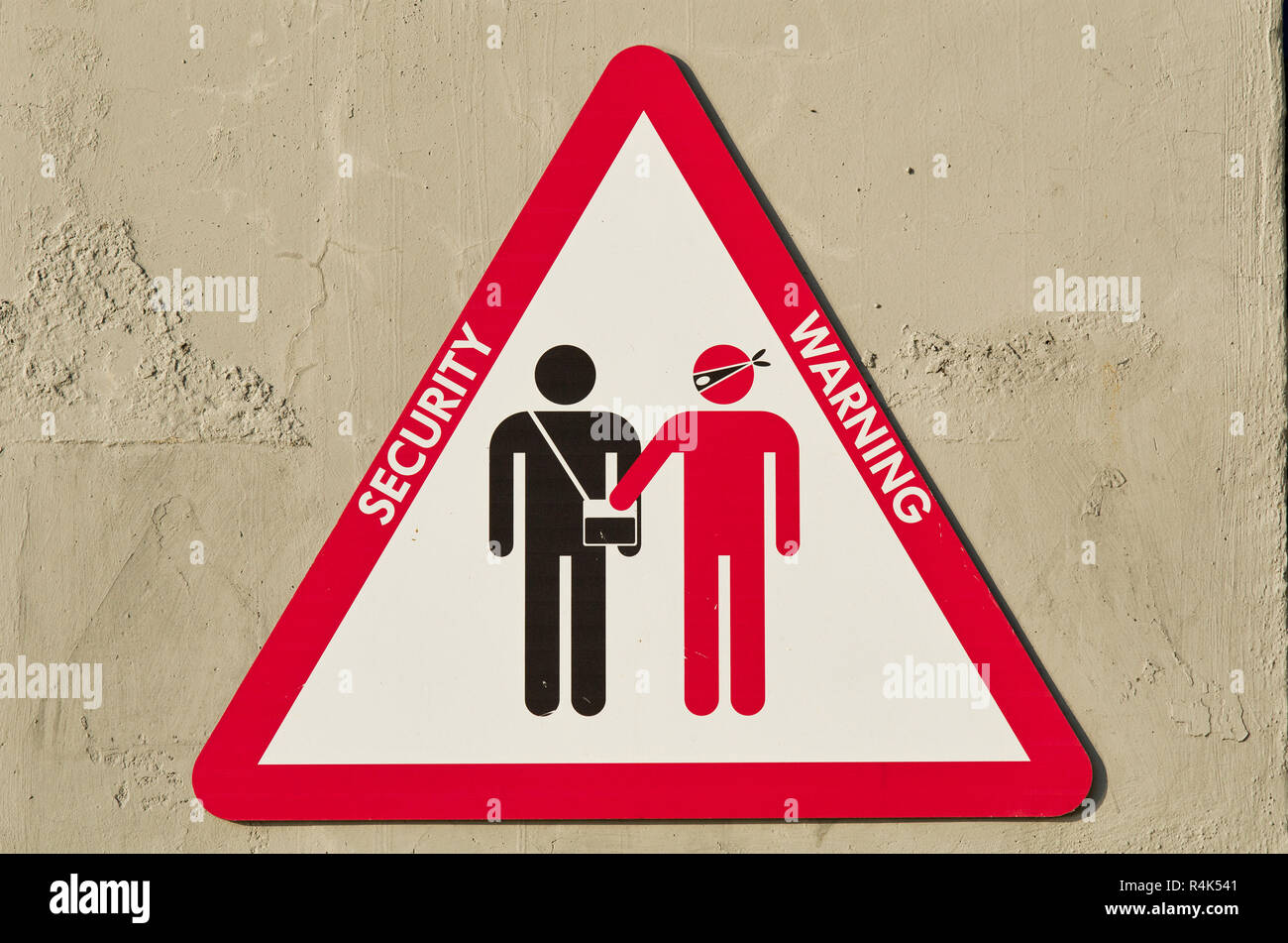 triangular sign to warn about the risk of being robbed Stock Photo - Alamy