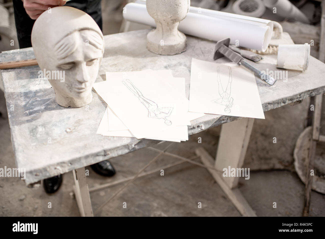 Working place with old sculptures, working tools and drawings on the ...