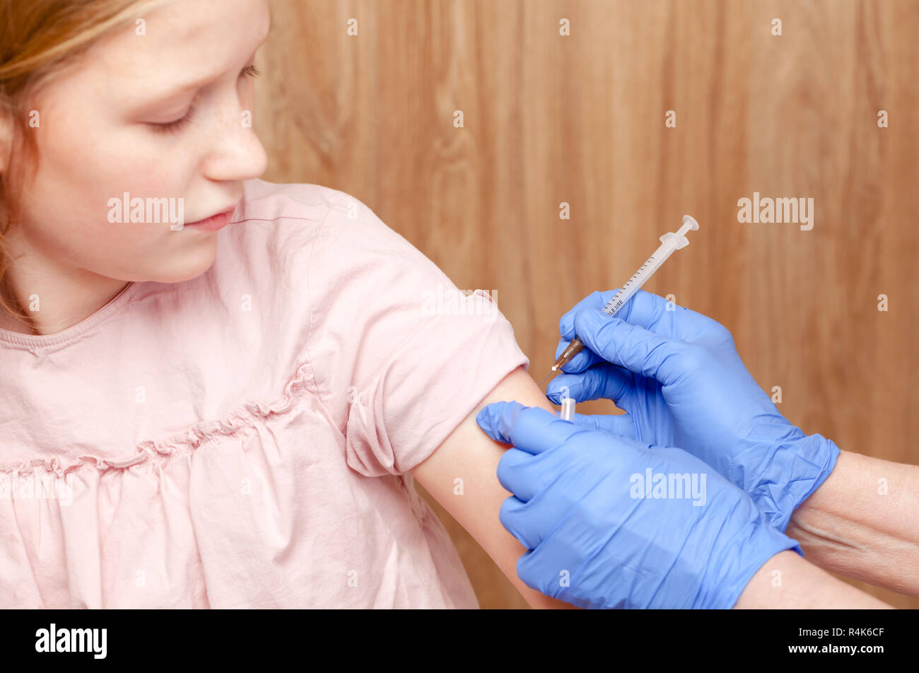 Close-up shot of pediatrician giving an intramuscular injection of a ...
