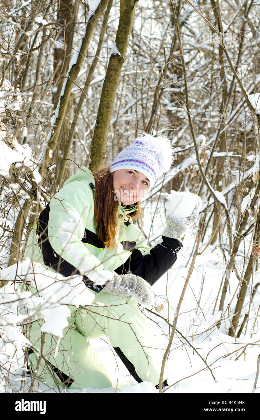 woman in winter throwing snowball Stock Photo - Alamy