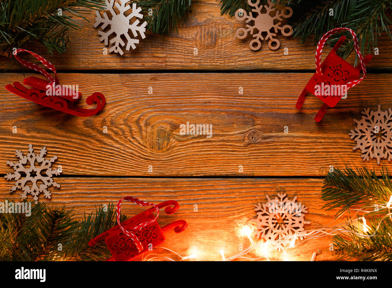 Photo of wooden surface with branches of spruce, New Year's toys Stock ...