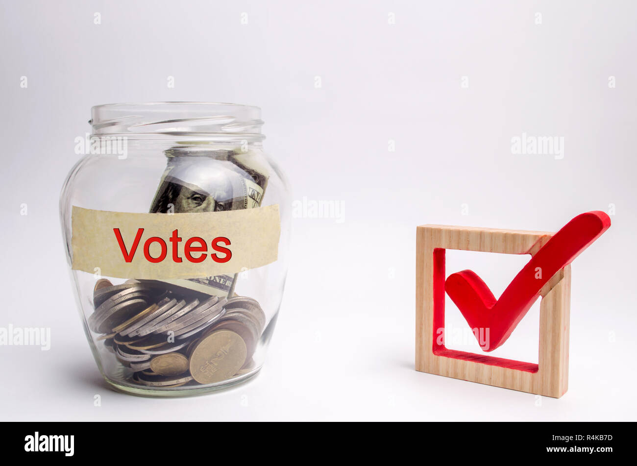 Glass jar with coins and the words Votes and a checkbox. Concept of ...