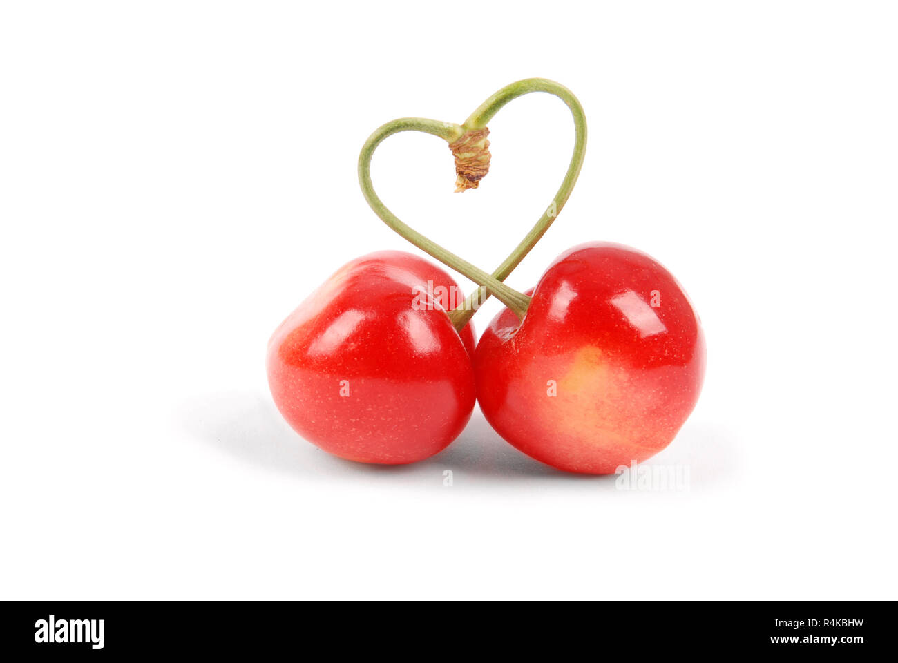 Pair of sweet cherry fruits with heart shaped stem isolated on white ...
