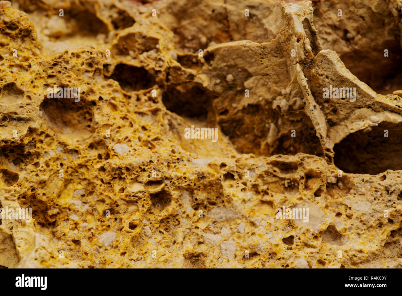 Natural stone wall background or texture. Limestone rock in close up ...