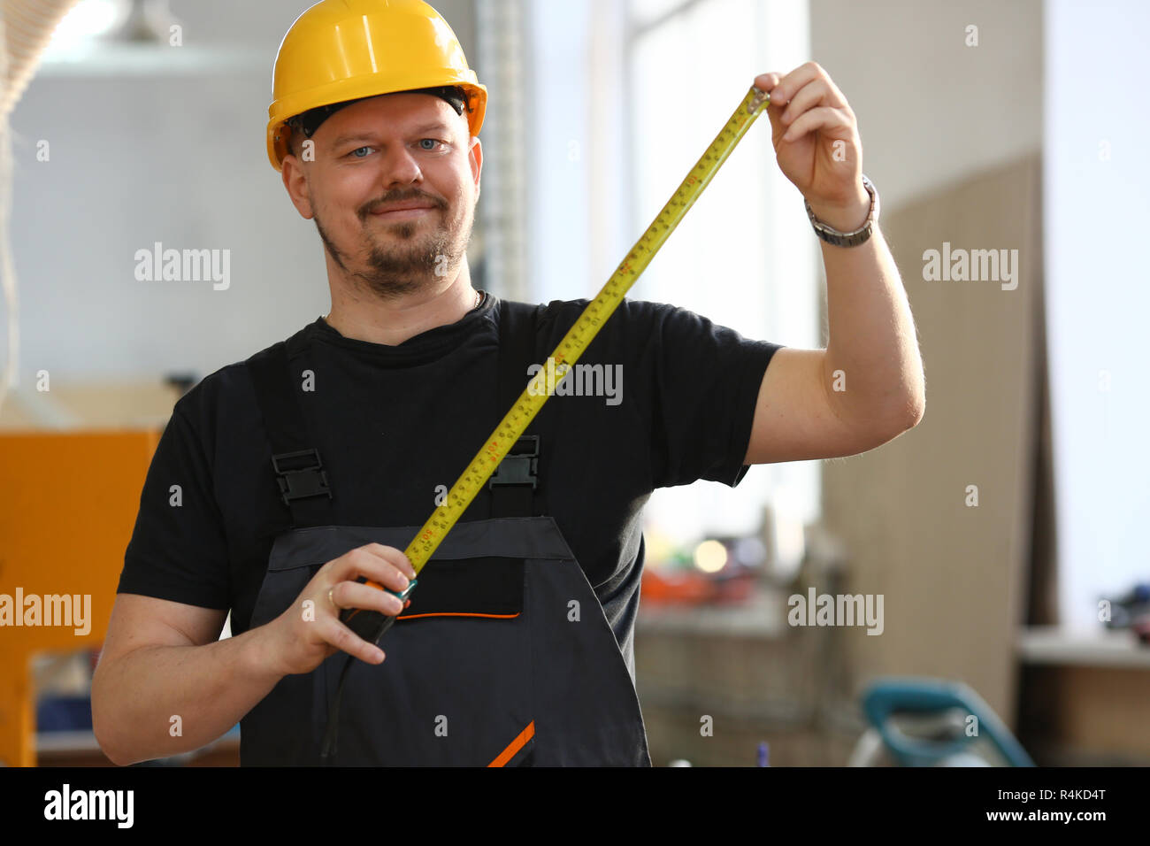 Arms of worker measuring wooden bar closeup Stock Photo - Alamy