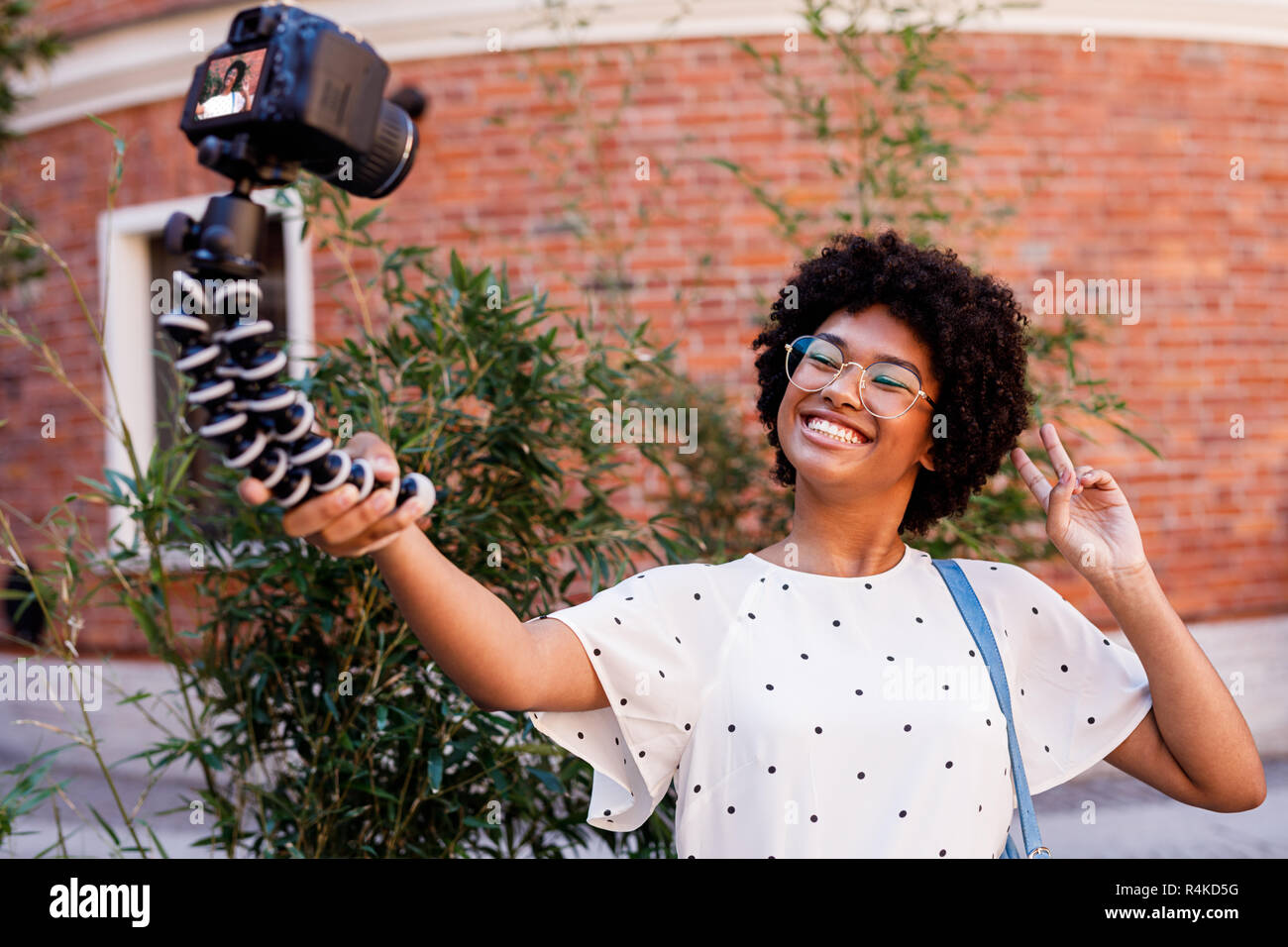 Happy girl filming on digital camera. Young vlogger making content ...