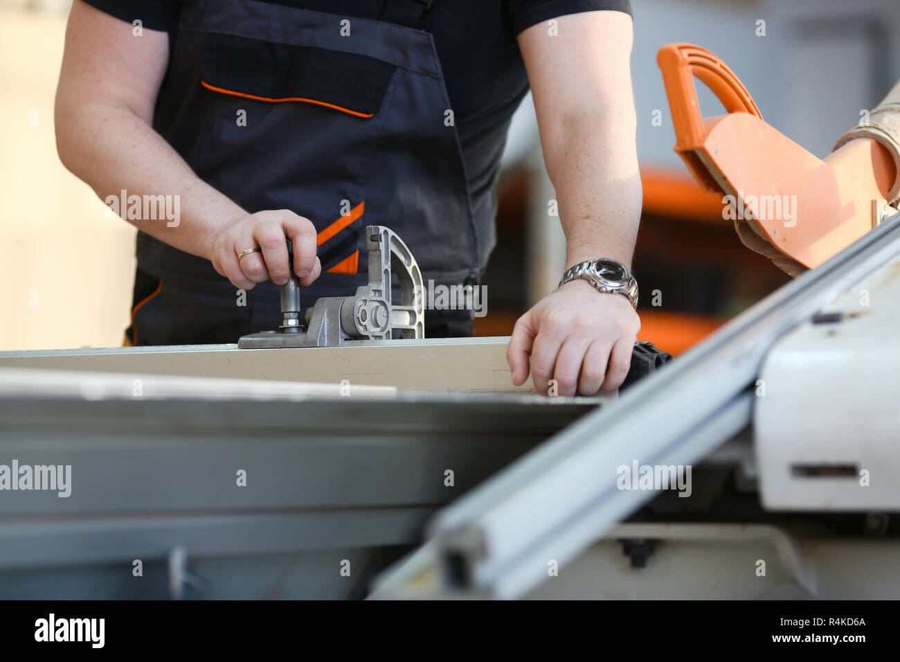 Worker using electric saw portrait Stock Photo - Alamy