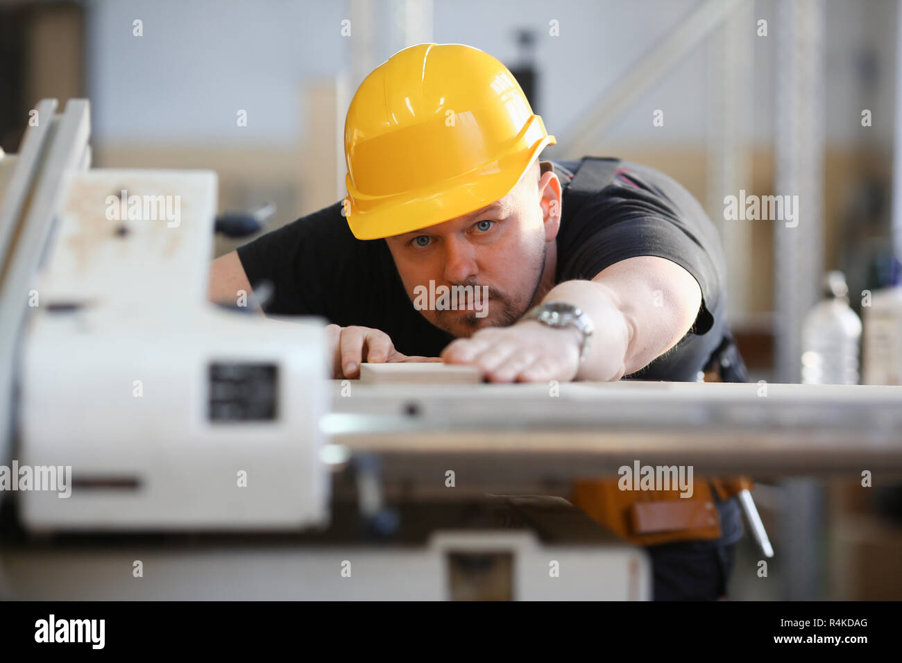 Worker using electric saw portrait Stock Photo - Alamy