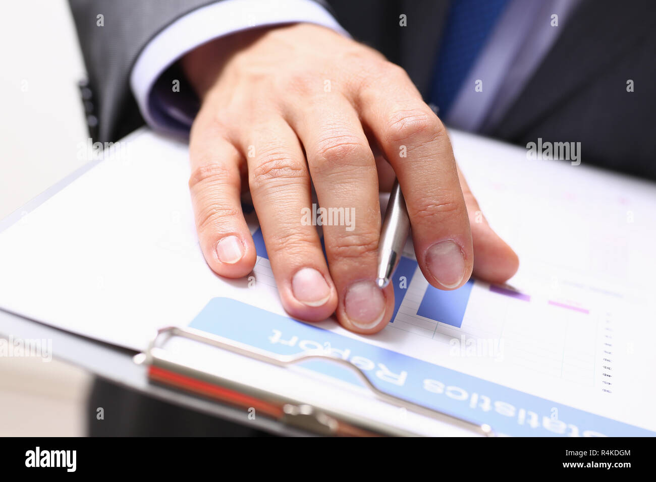 Male hands hold documents with financial statistics Stock Photo - Alamy