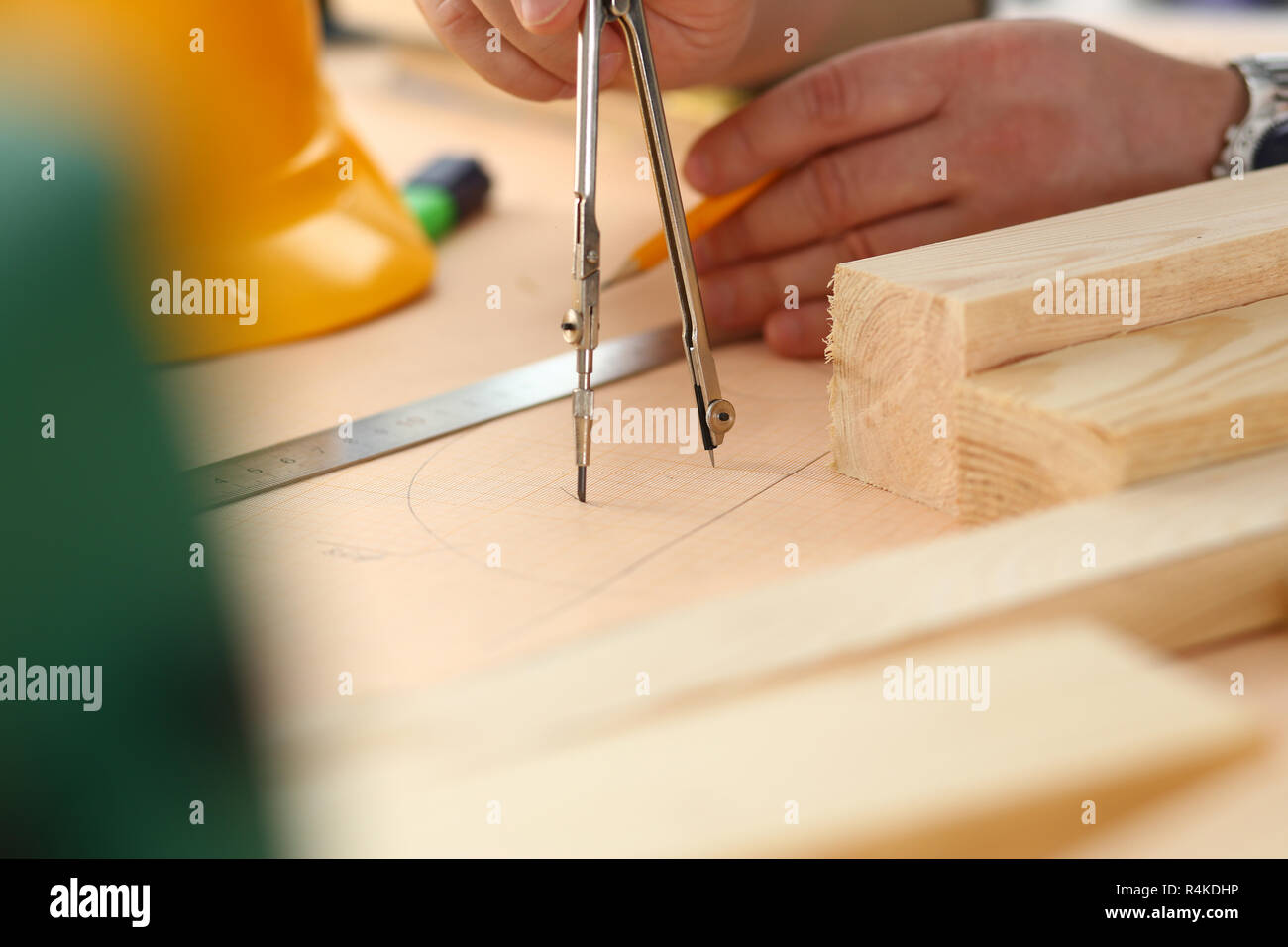 Arms of worker making structure plan on scaled paper Stock Photo - Alamy