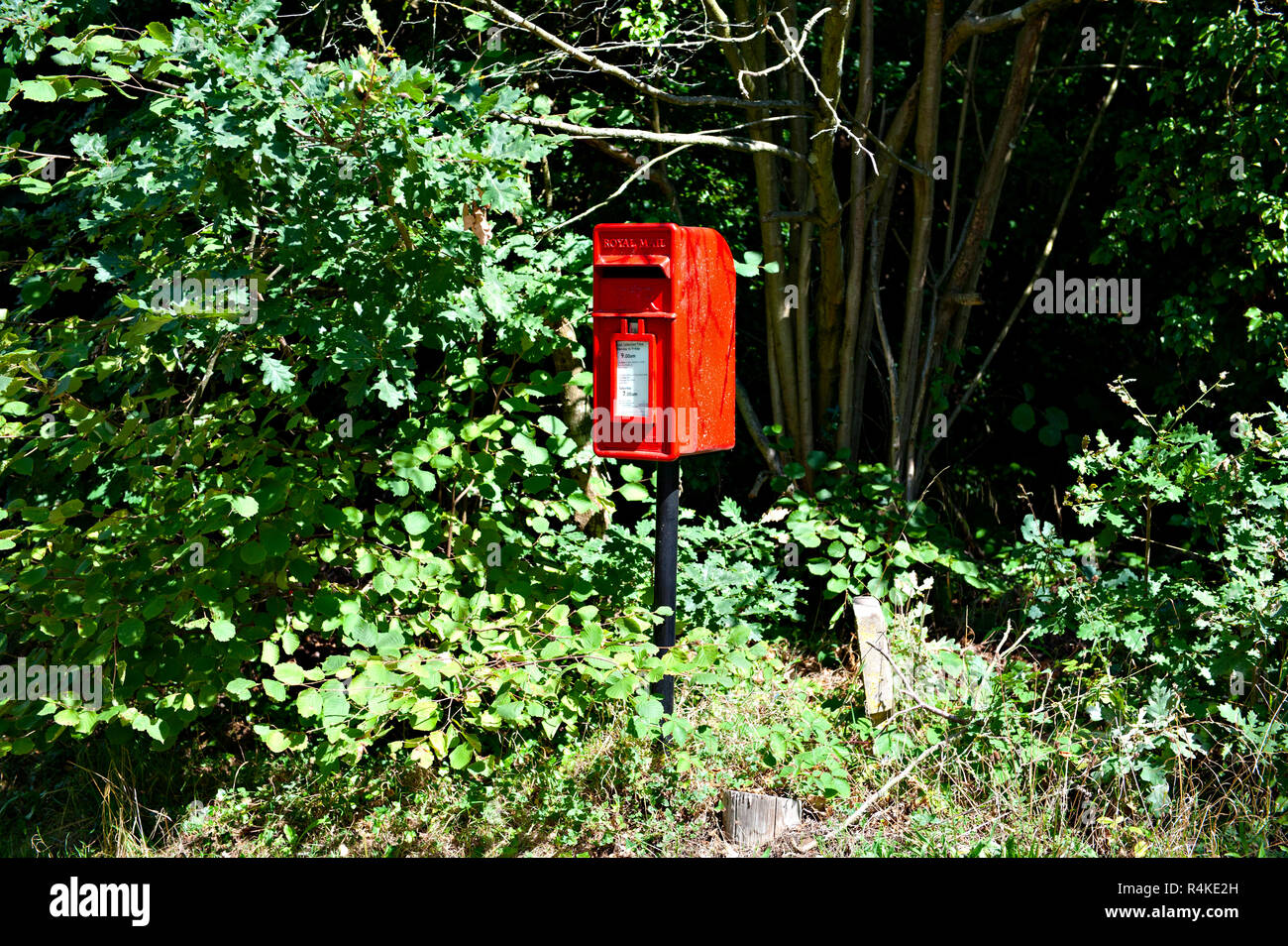 A small pedestal mounted Royal Mail post box situated in a rural ...