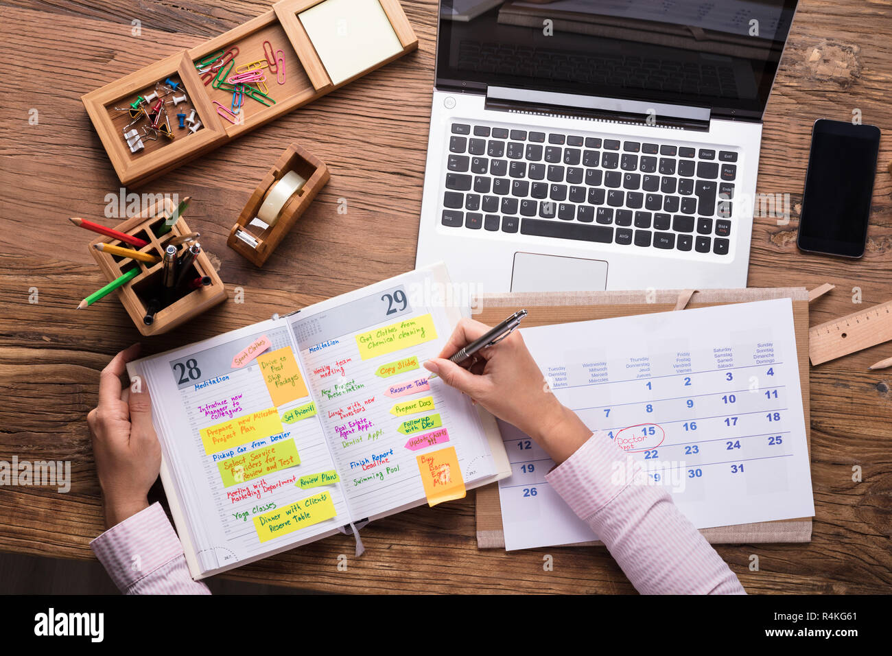 Businesswoman Writing Schedule In Calendar Diary Stock Photo - Alamy