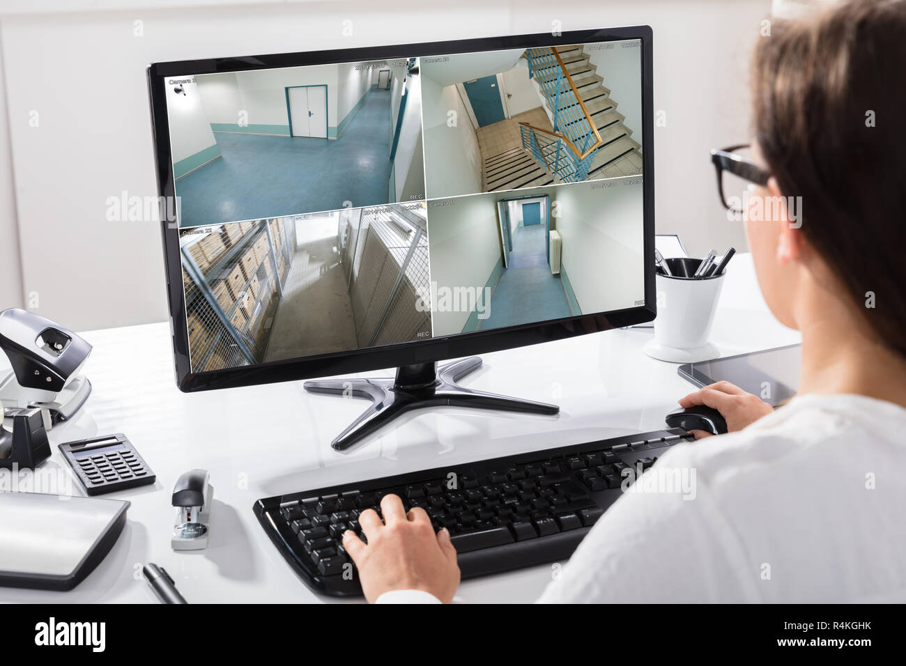Businesswoman Watching CCTV Footage On Computer Stock Photo - Alamy