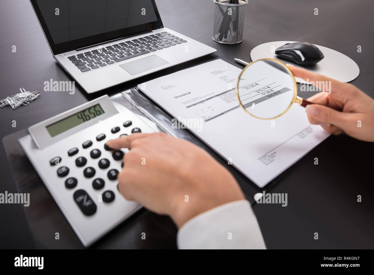 Businesswoman Looking Invoice Through Magnifying Glass Stock Photo - Alamy